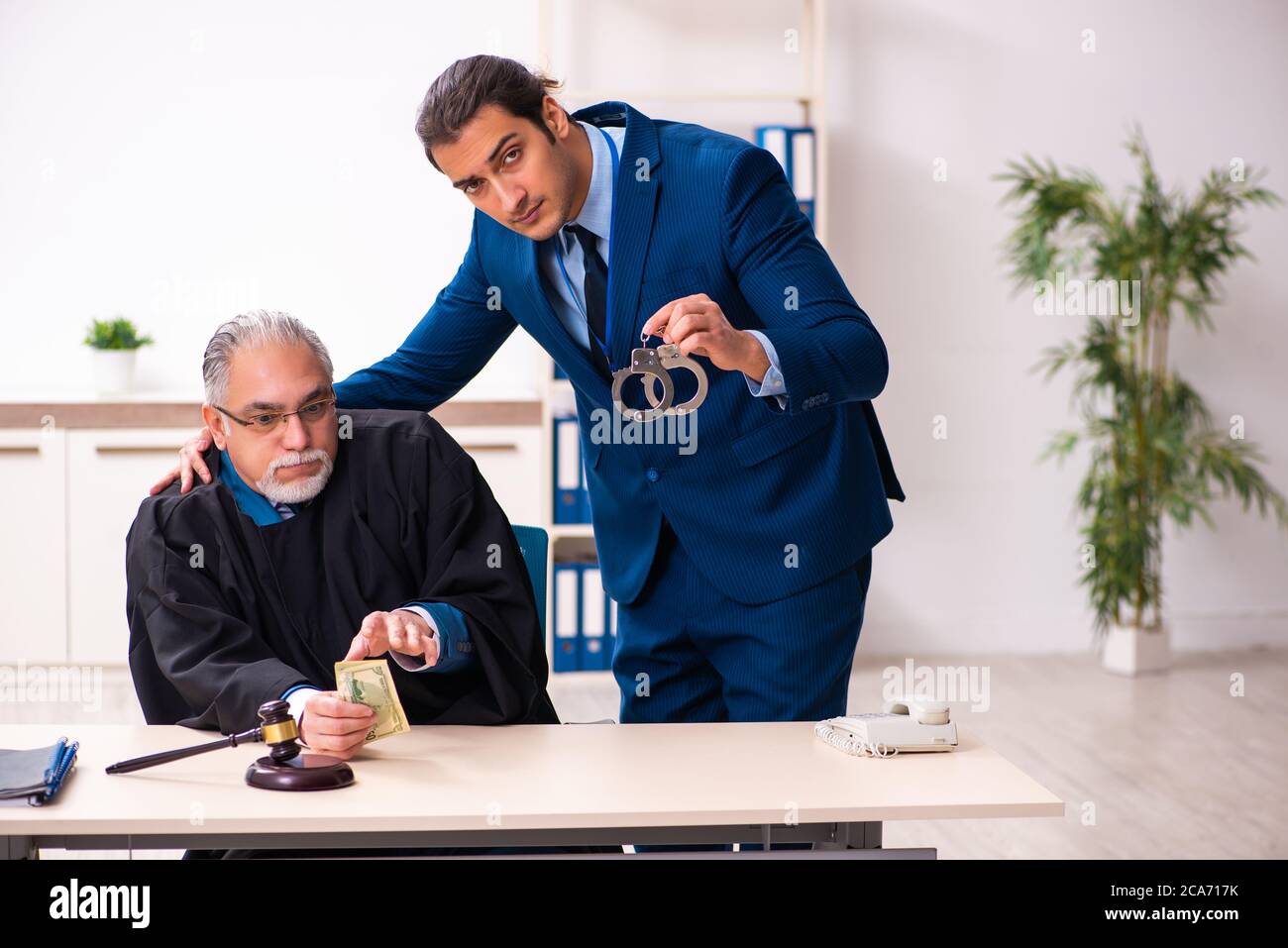 Police inspector arresting judge in court Stock Photo - Alamy