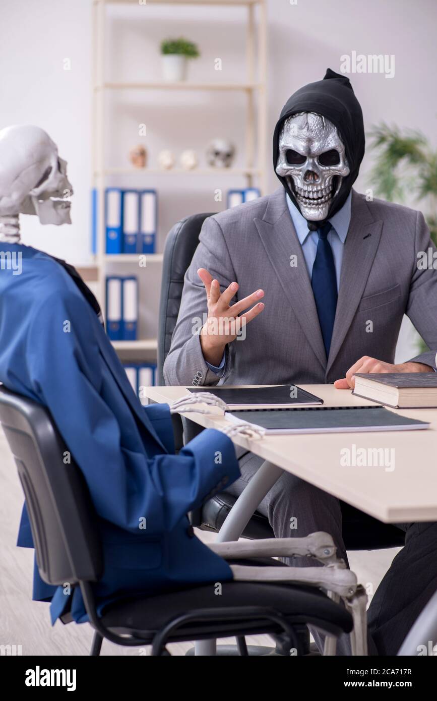 Funny business meeting with the devil and skeletons Stock Photo - Alamy