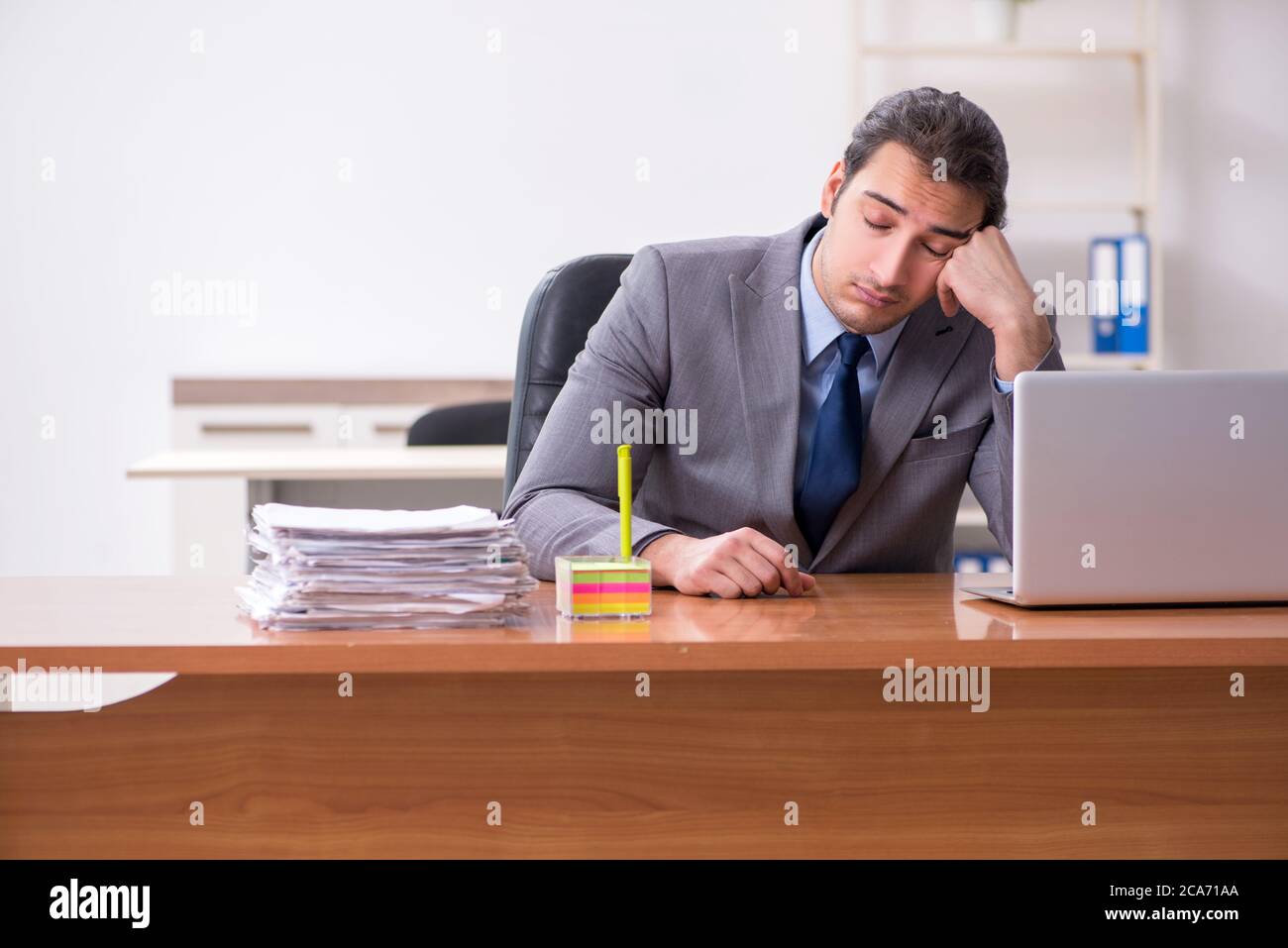 Young employee sleeping in the office Stock Photo - Alamy