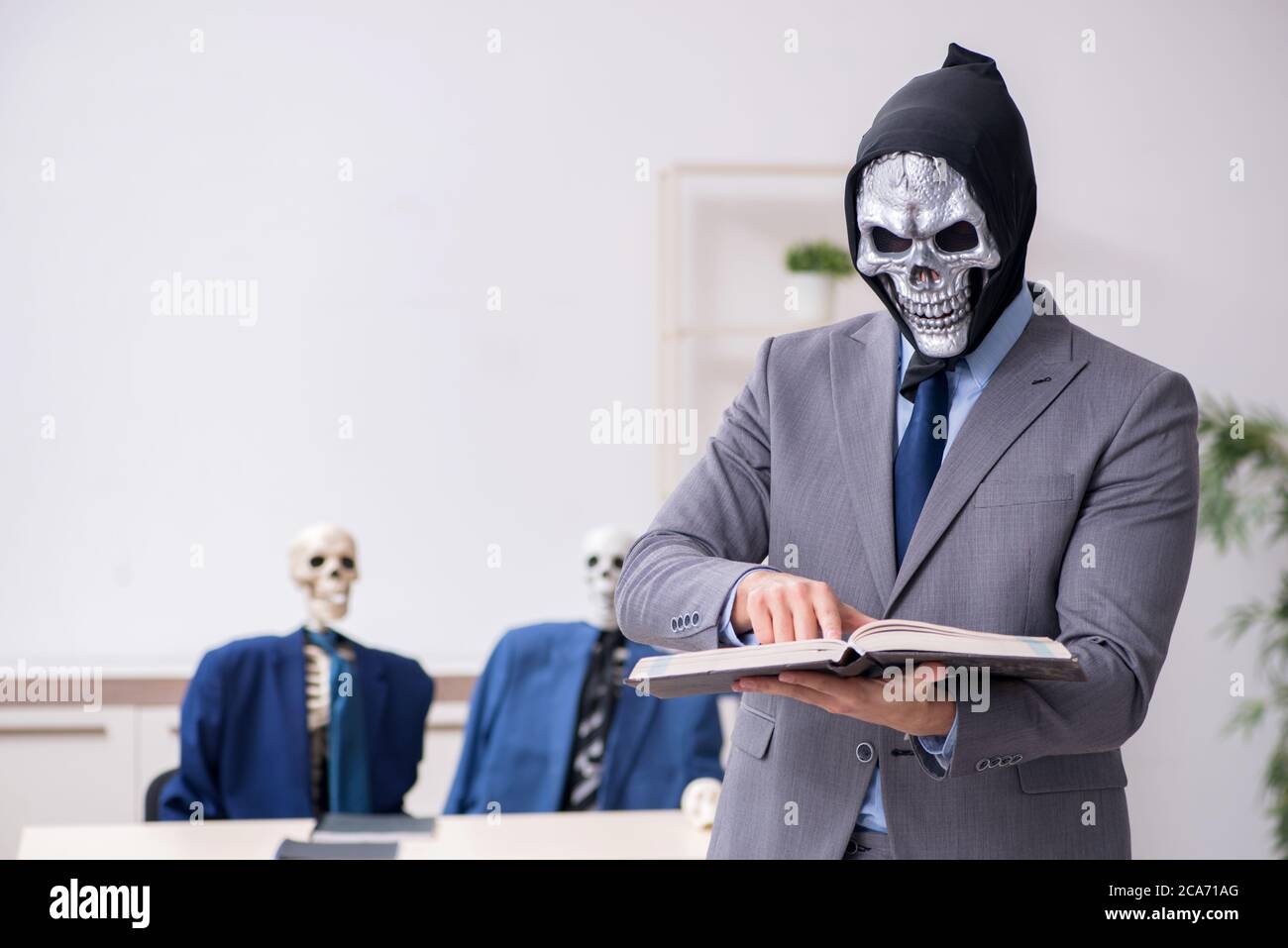 Funny business meeting with the devil and skeletons Stock Photo - Alamy