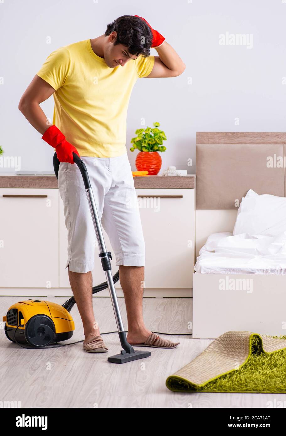 Man vacuuming bed hi-res stock photography and images - Alamy