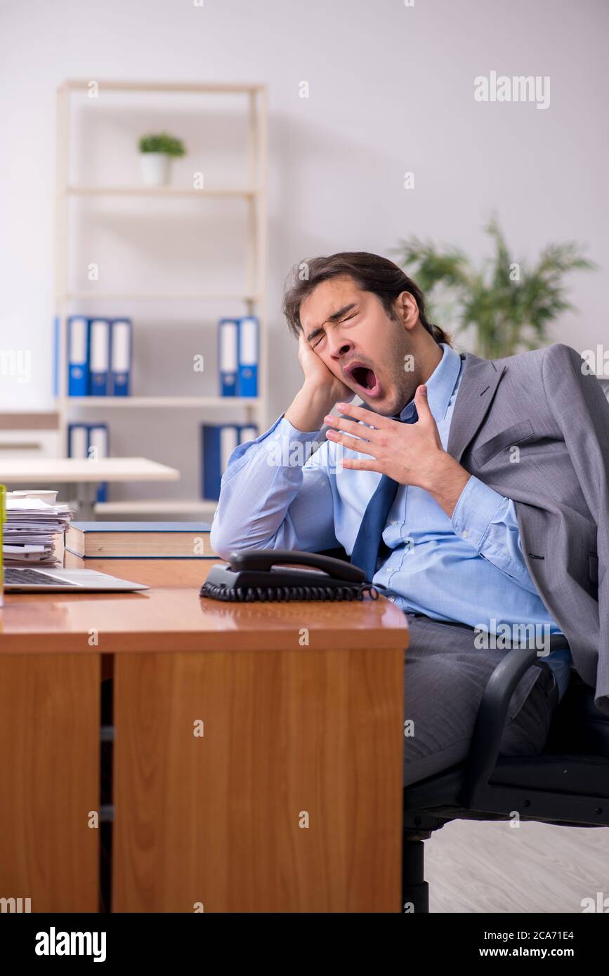 Young employee sleeping in the office Stock Photo - Alamy