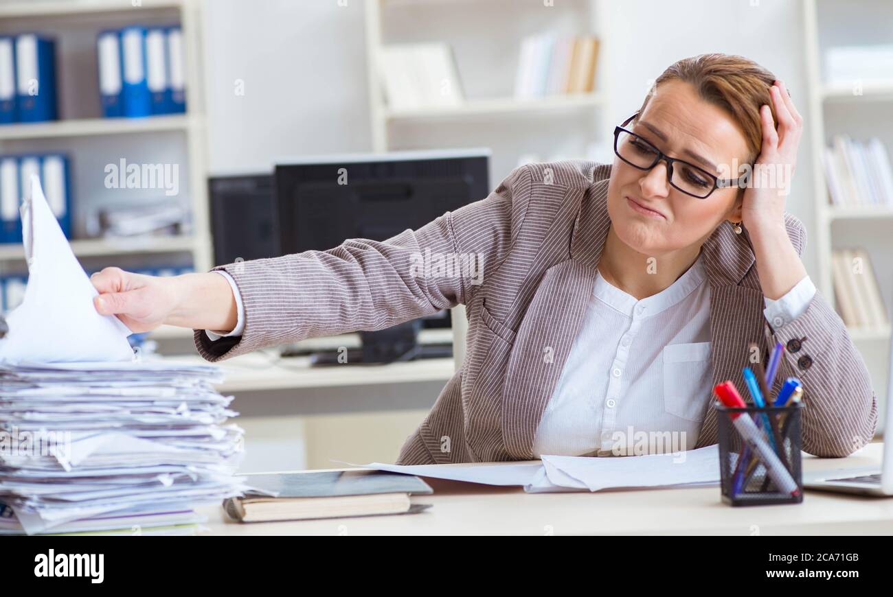 The businesswoman very busy with ongoing paperwork Stock Photo - Alamy