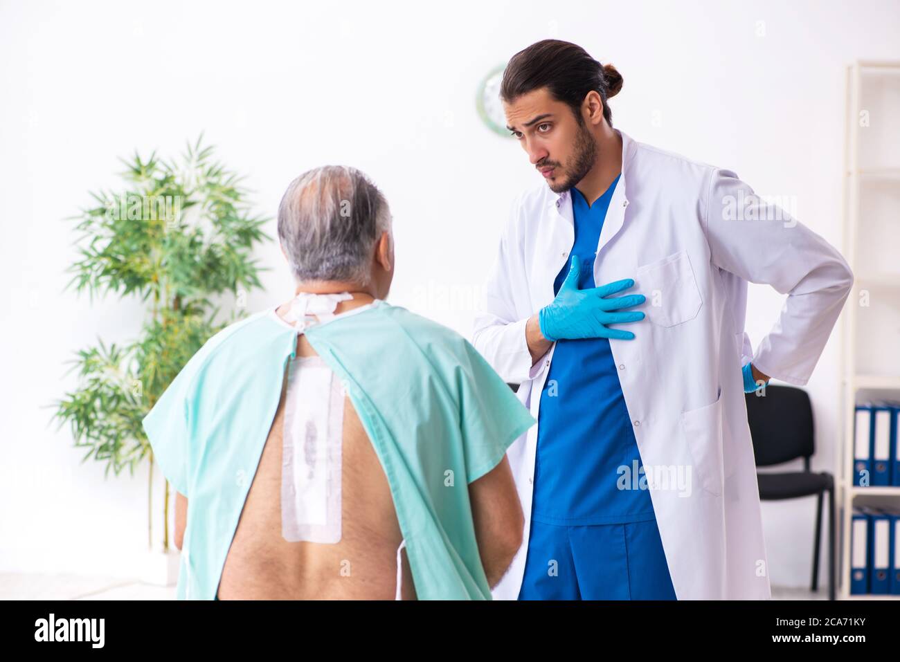 Old man visiting male doctor Stock Photo - Alamy