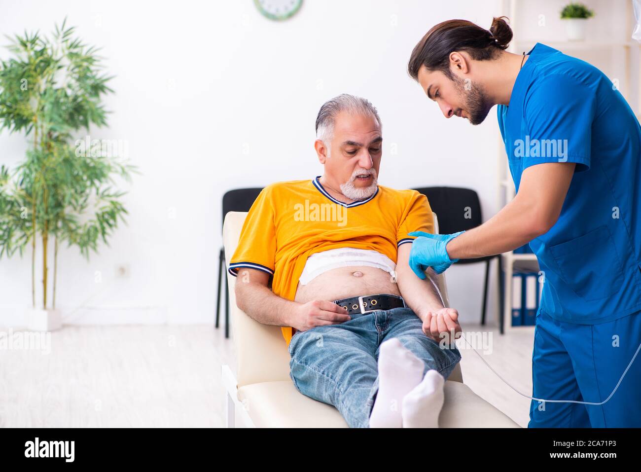 Old man visiting male doctor Stock Photo - Alamy