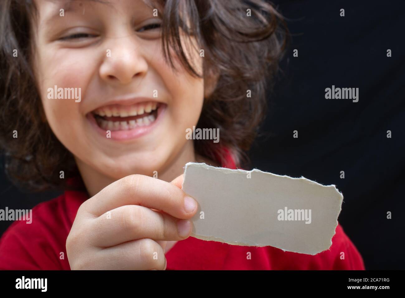 Little cute boy with adorable and happy smiling boy holding a torn ...