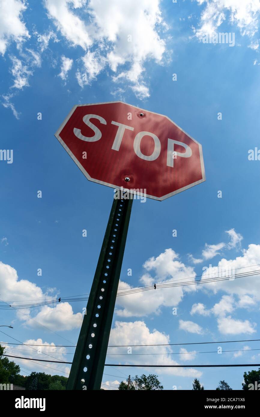 Stop sign with bright blue sky with fluffy clouds Stock Photo - Alamy
