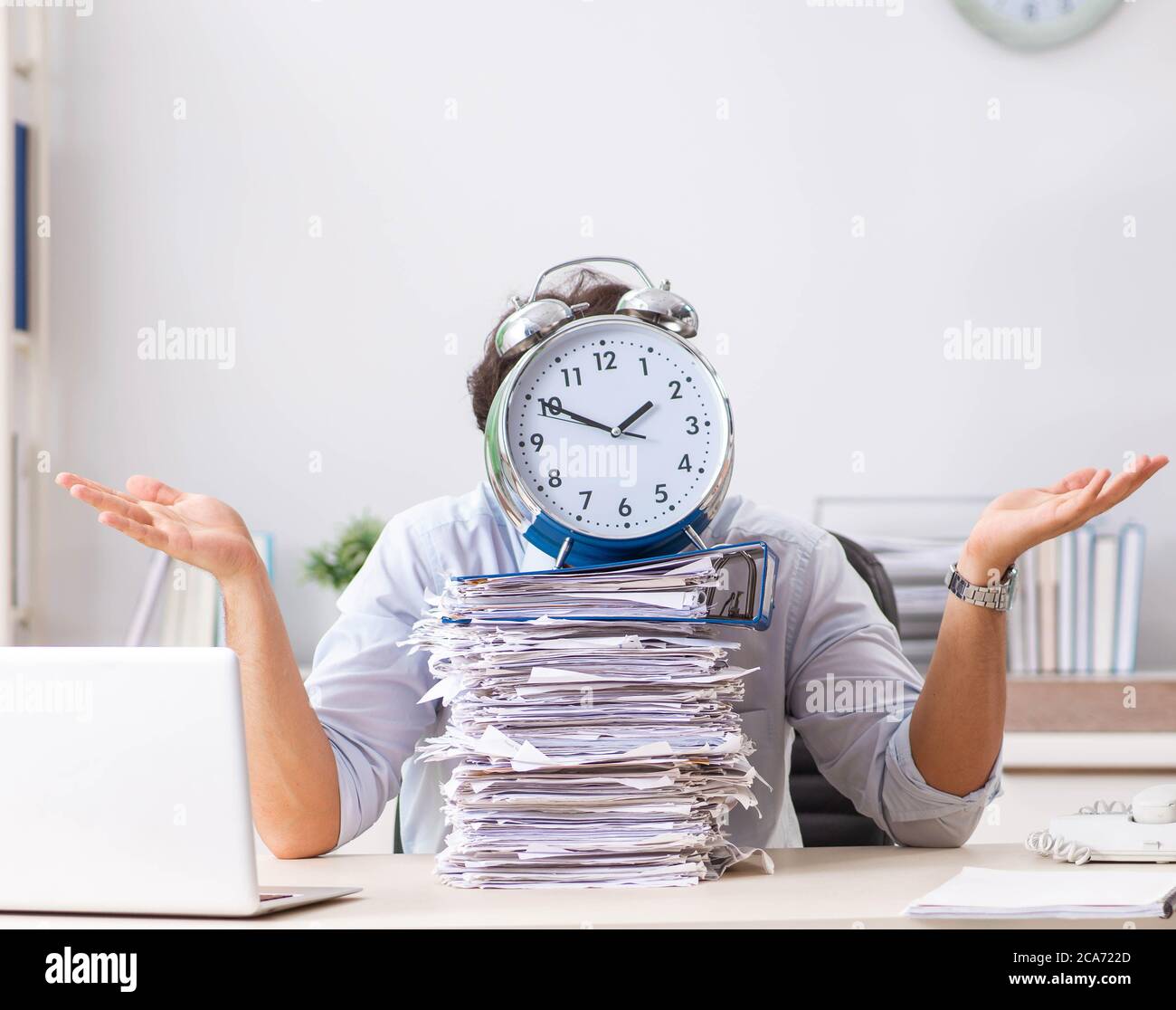 The overloaded busy employee with too much work and paperwork Stock ...