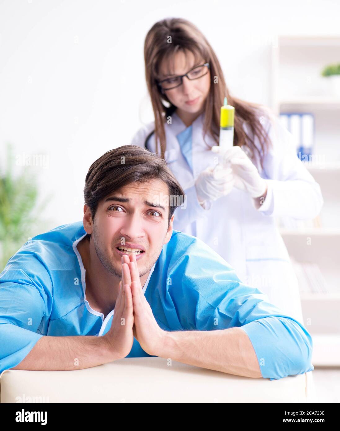 The funny man getting ready for buttocks syringe shot Stock Photo - Alamy