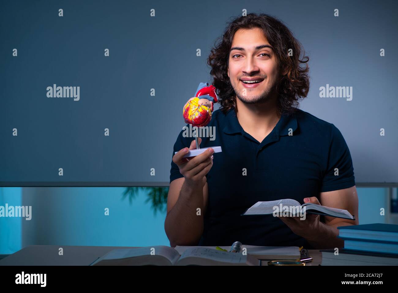 Young student in the classroom at night Stock Photo - Alamy
