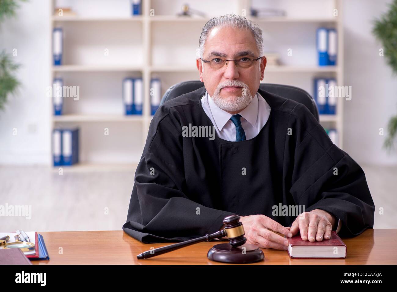 Old male judge working in the courthouse Stock Photo - Alamy