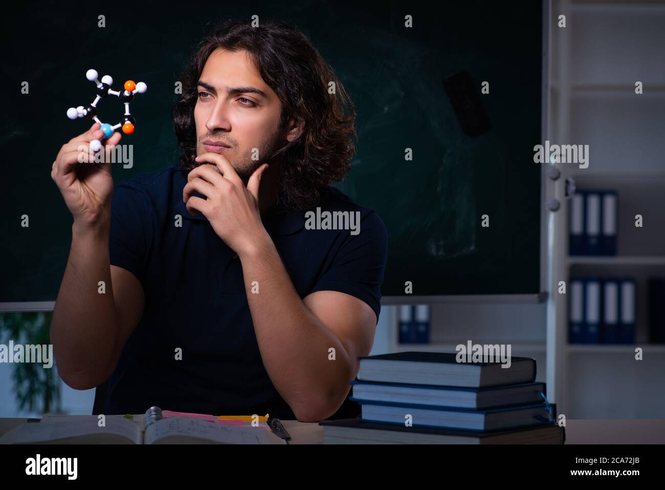 Young student in the classroom at night Stock Photo - Alamy
