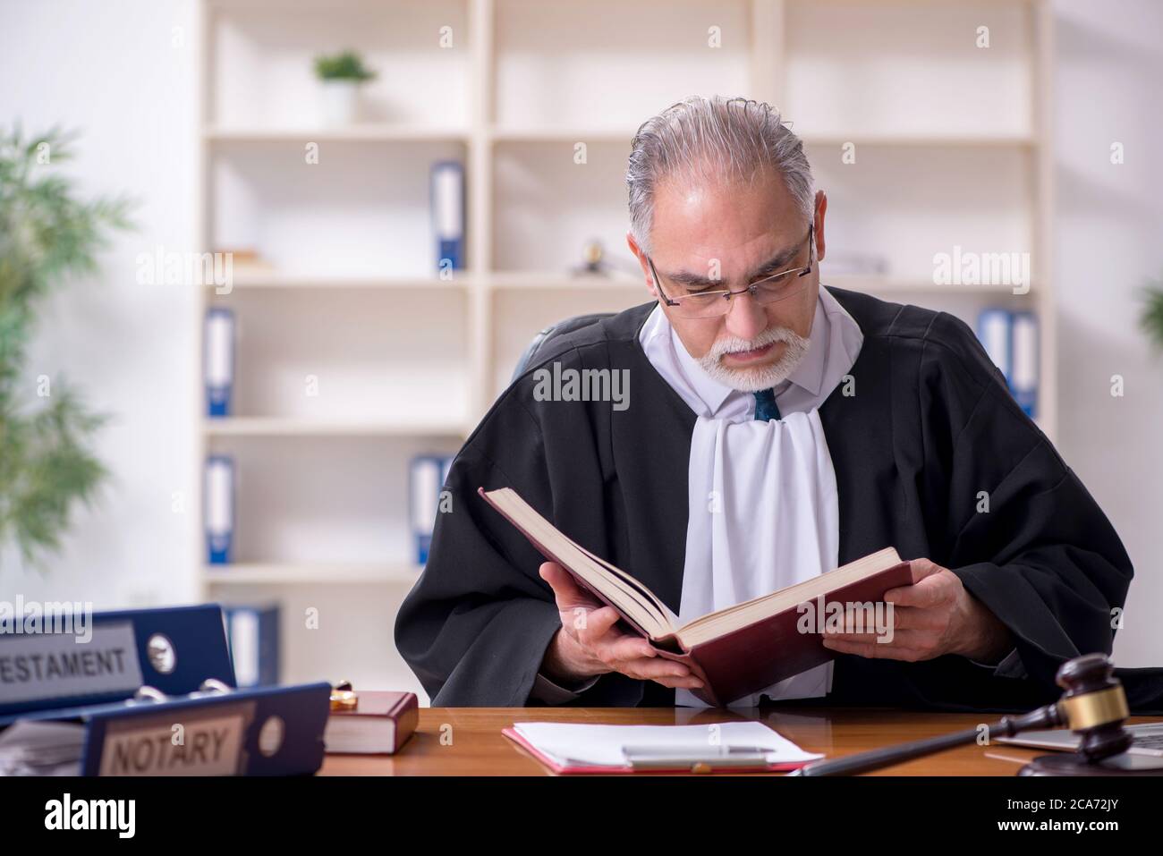 Old male judge working in the courthouse Stock Photo - Alamy