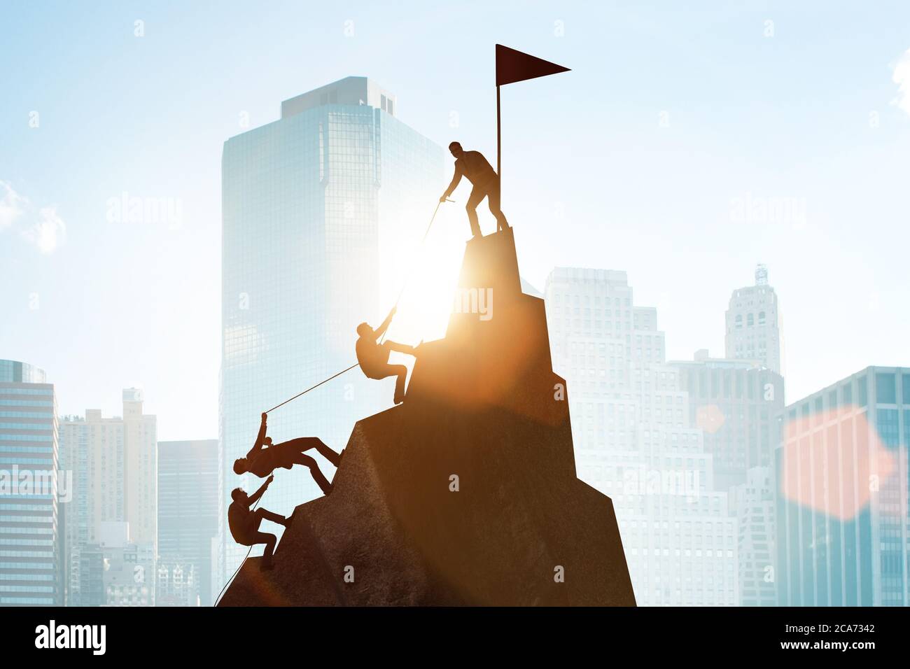Concept of teamwork with team climbing mountain Stock Photo - Alamy