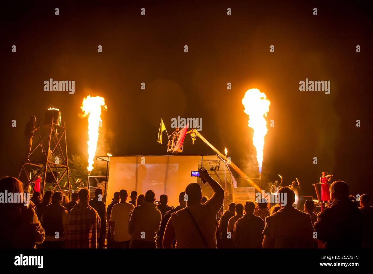 A crowd of people watching a fire show performance of the open air ...