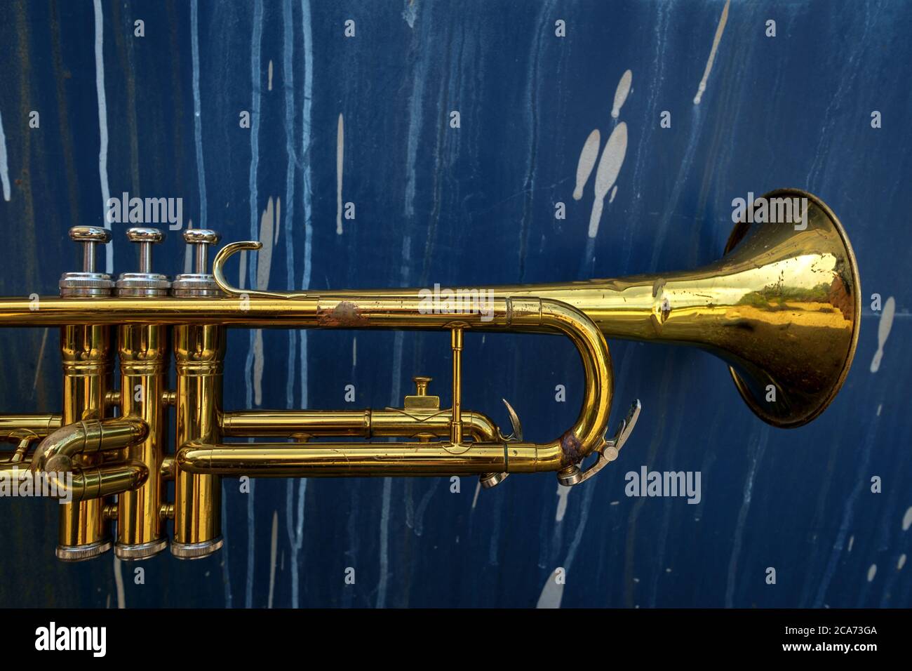 Old rusty Jazz instrument trumpet against distressed grunge background ...