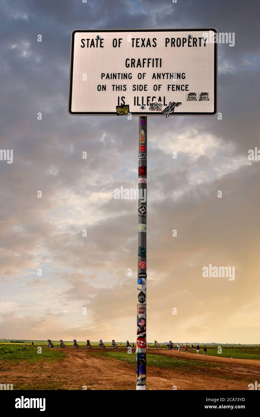 Sign at the entrance to Cadillac Ranch - grafitti is illegal in Texas ...