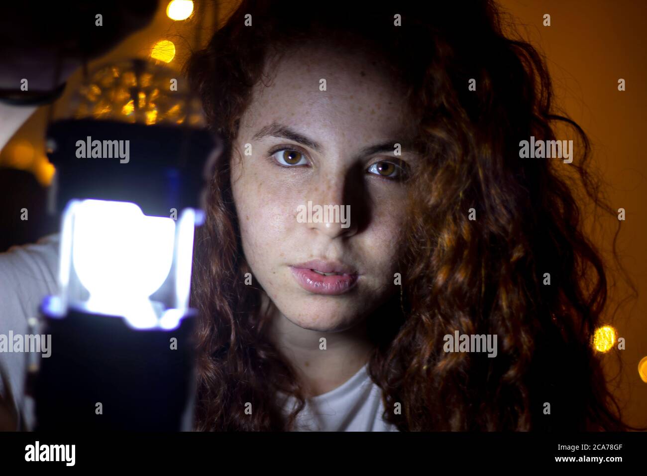 Redhead with lights Stock Photo - Alamy