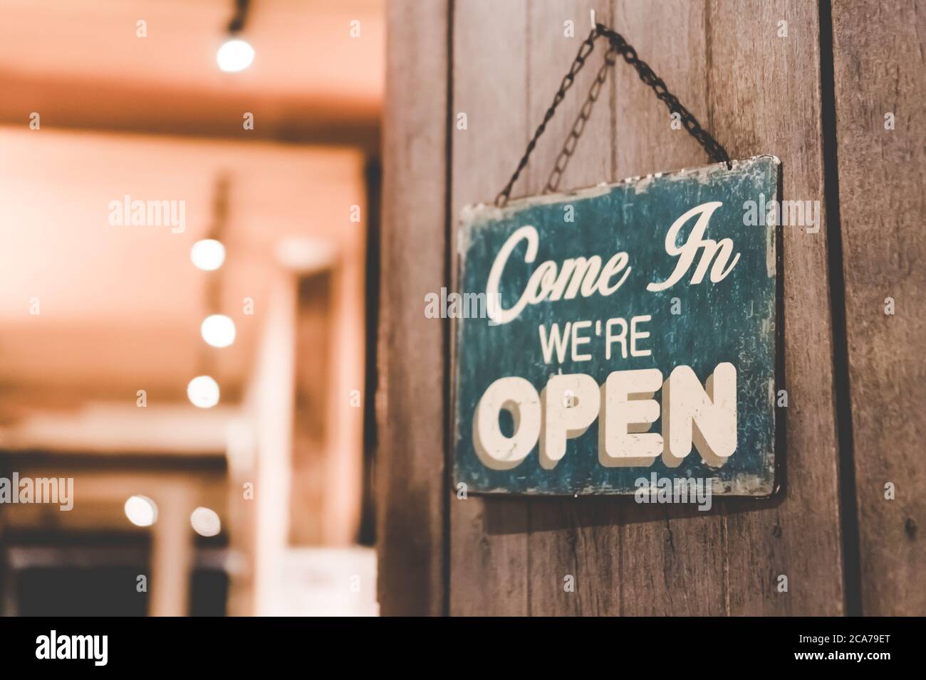 A business sign that says open on cafe or restaurant hang on door at ...