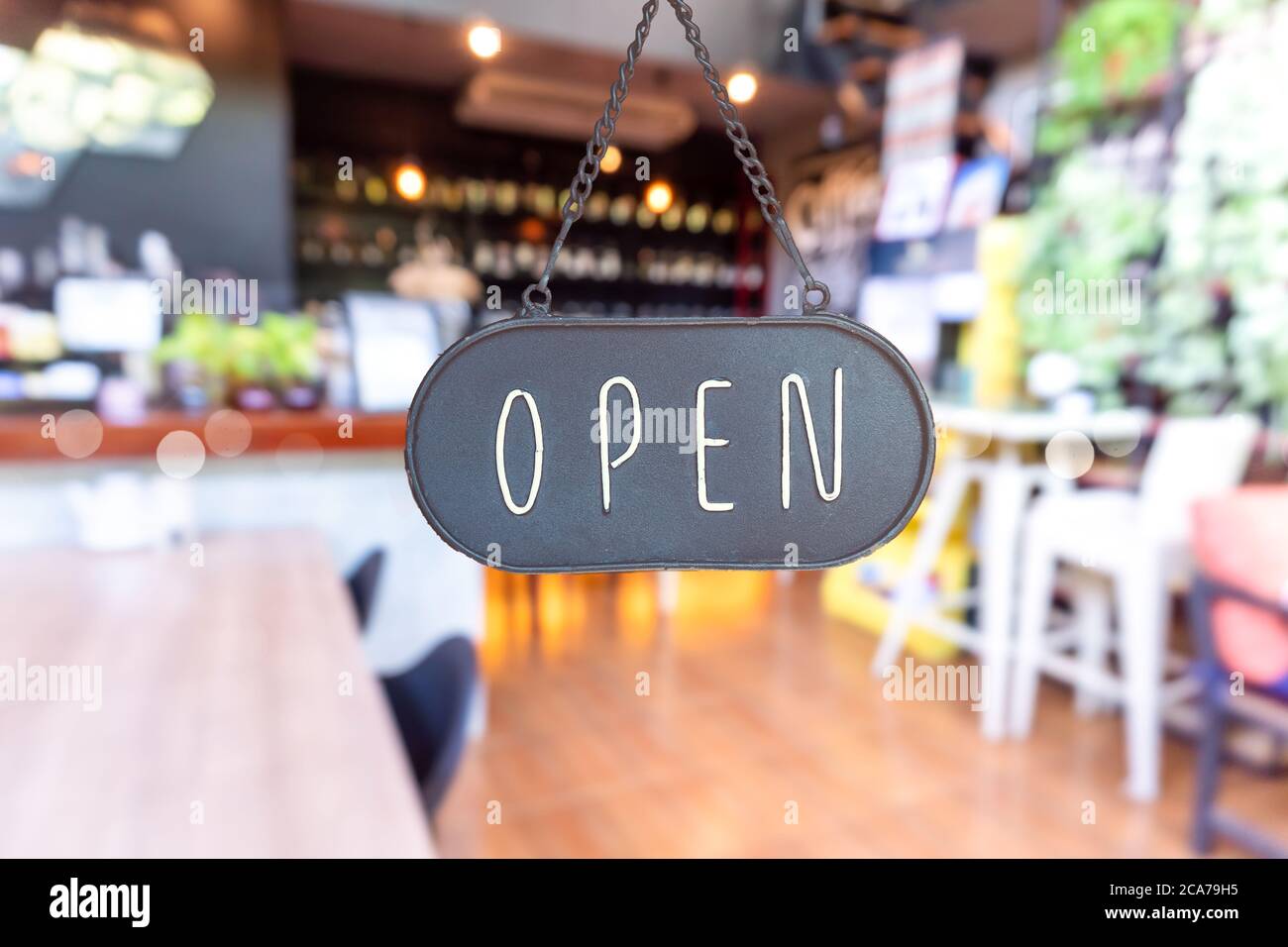 A business sign that says open on cafe or restaurant hang on door at ...