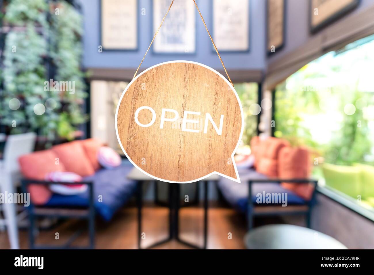 A business sign that says open on cafe or restaurant hang on door at ...