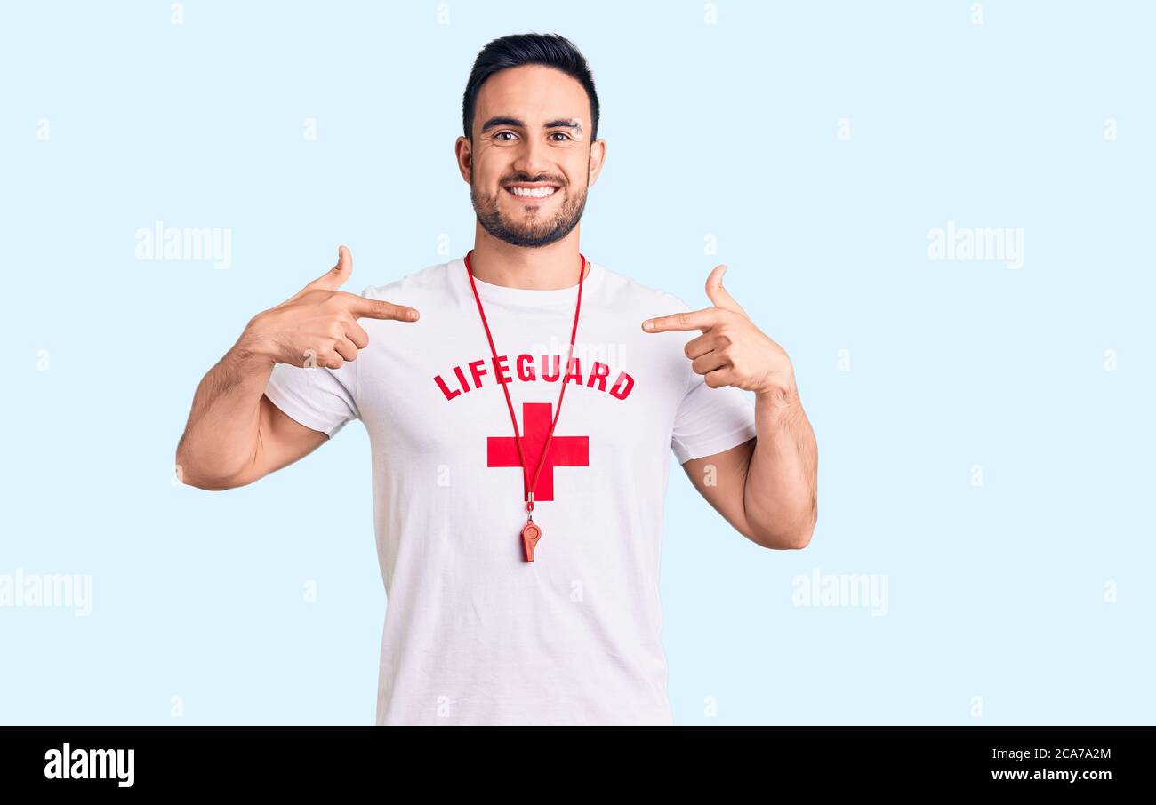 Young handsome man wearing lifeguard uniform looking confident with ...