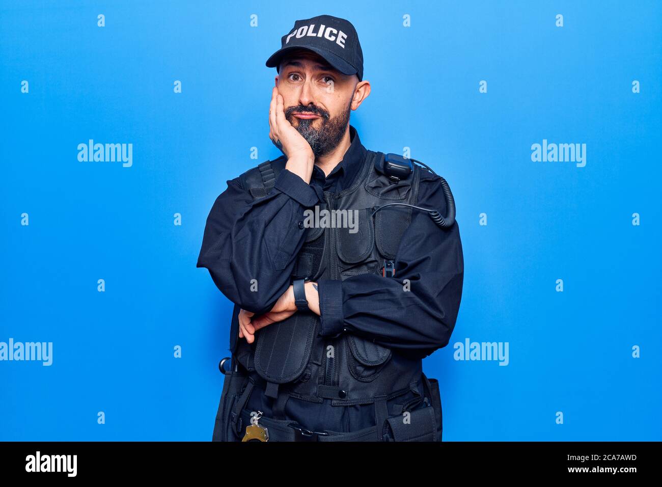 Young handsome man wearing police uniform thinking looking tired and ...