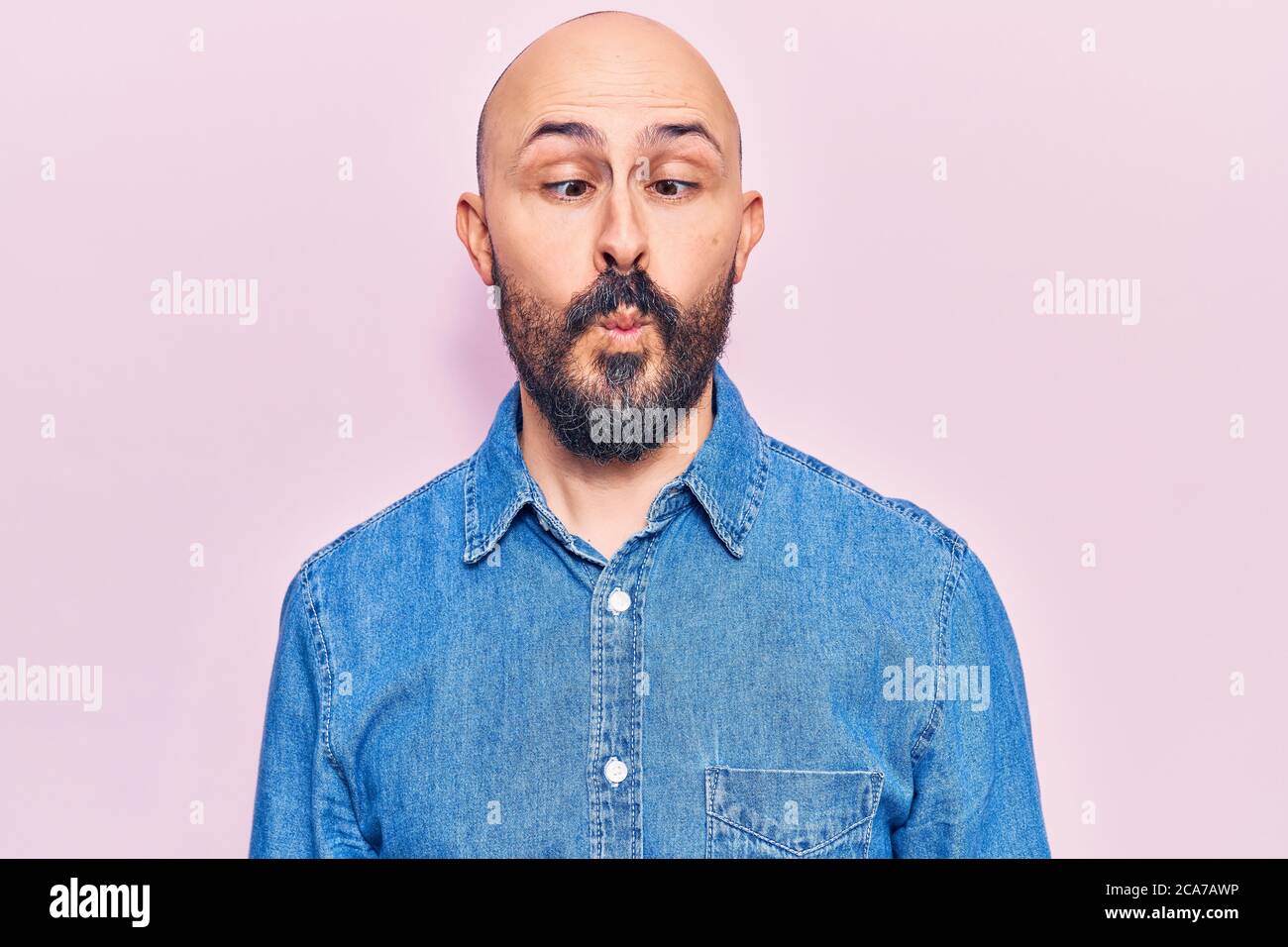 Young handsome man wearing casual clothes making fish face with lips ...