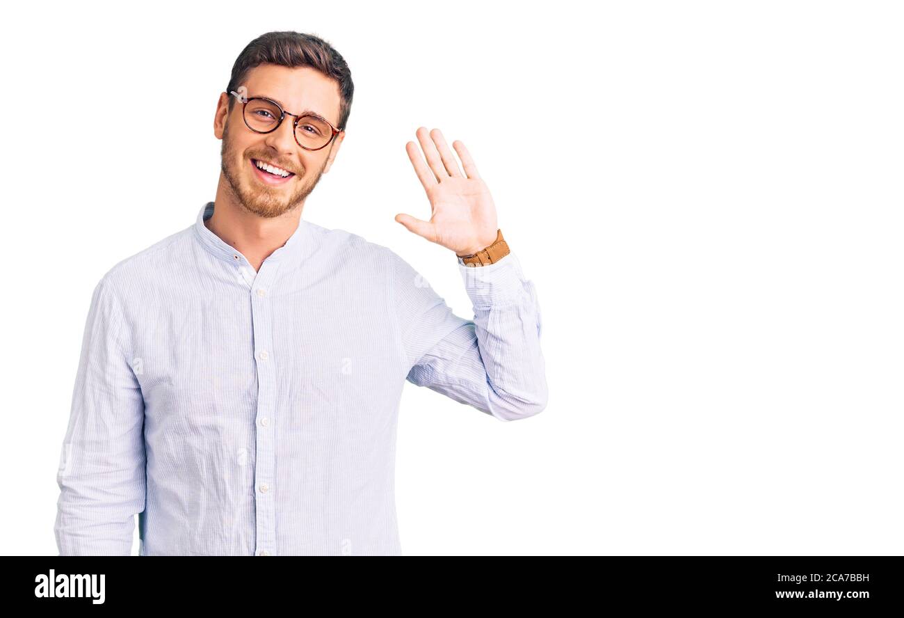 Handsome young man with bear wearing elegant business shirt and glasses ...