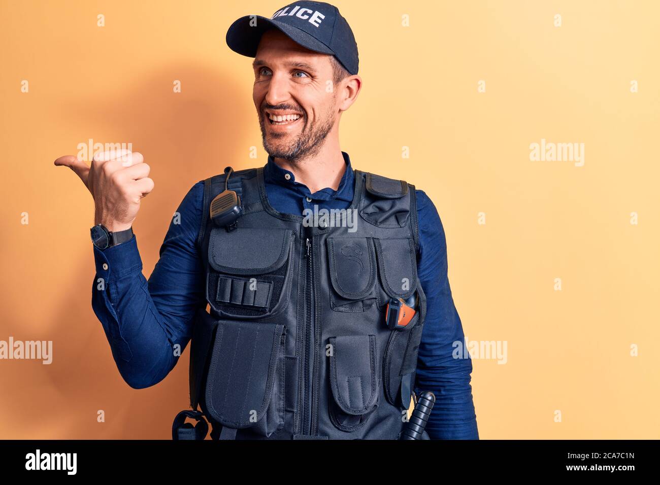 Young handsome policeman wearing police uniform and bulletprof over ...