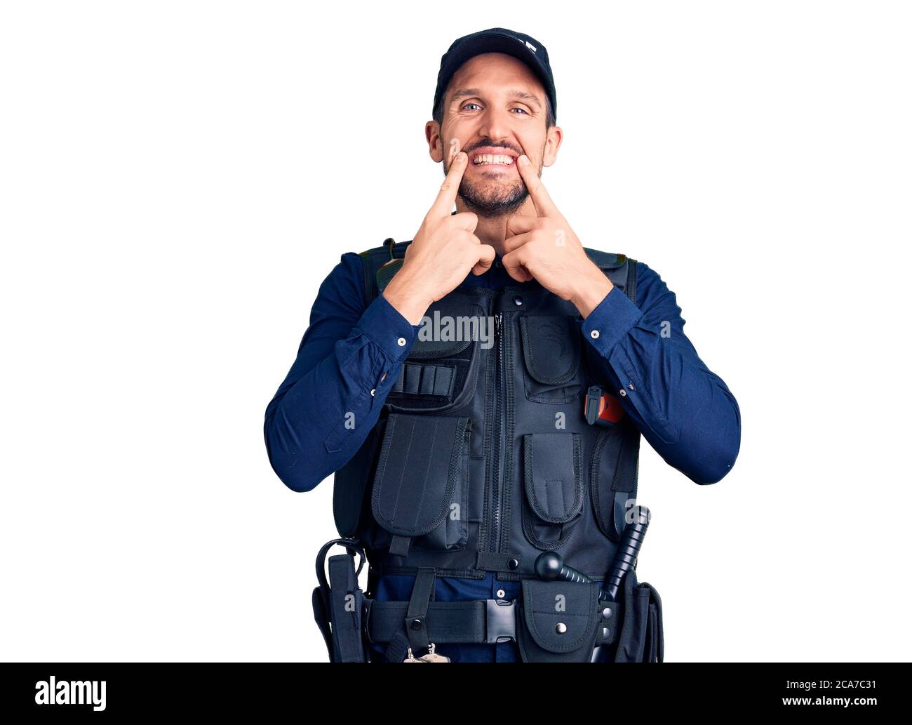 Young handsome man wearing police uniform smiling with open mouth ...