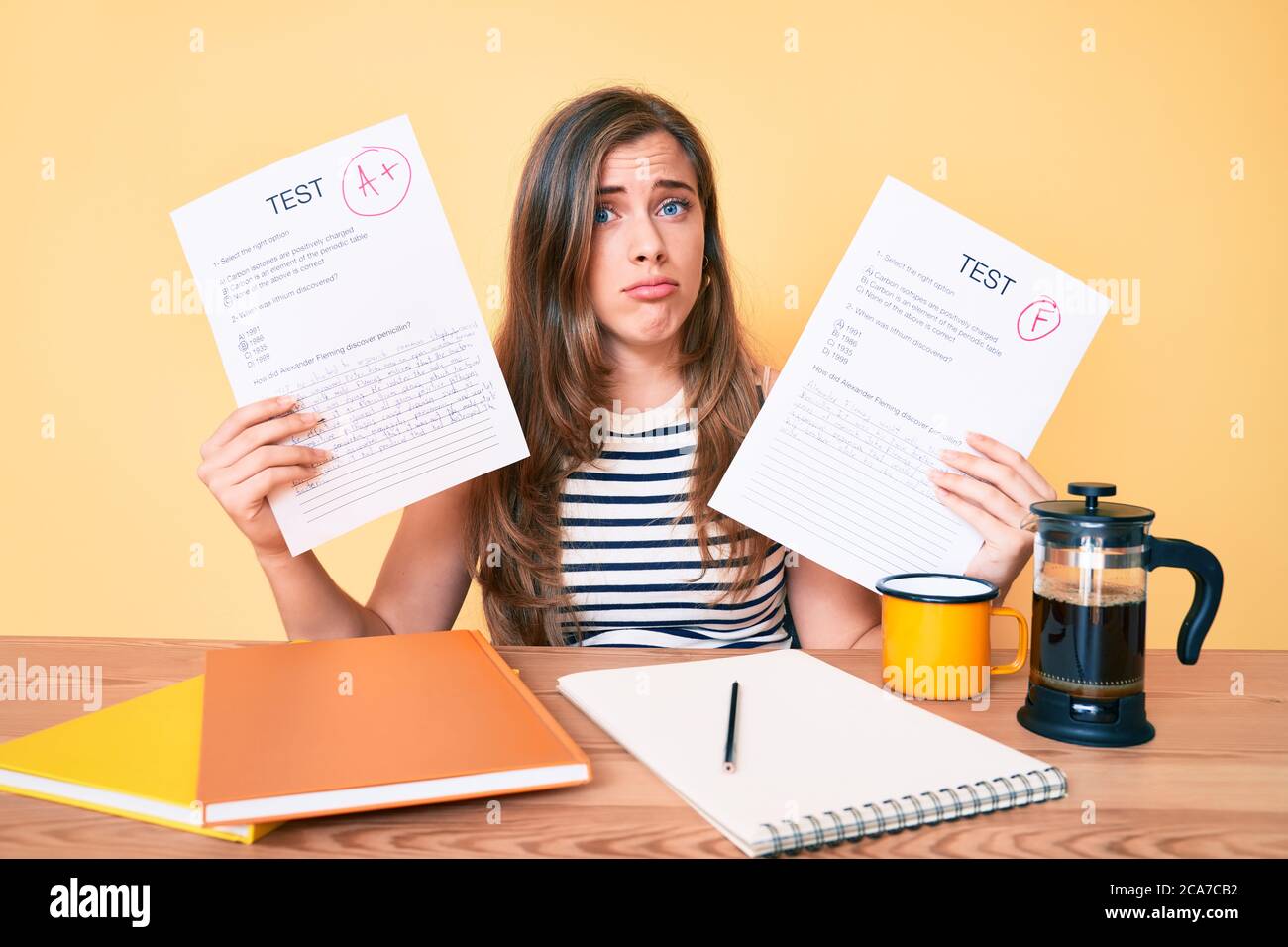 Young beautiful caucasian woman showing failed and passed exam sitting ...