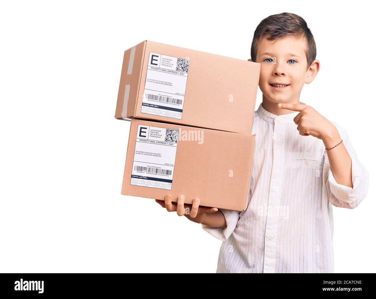 Cute blond kid holding delivery package smiling happy pointing with ...