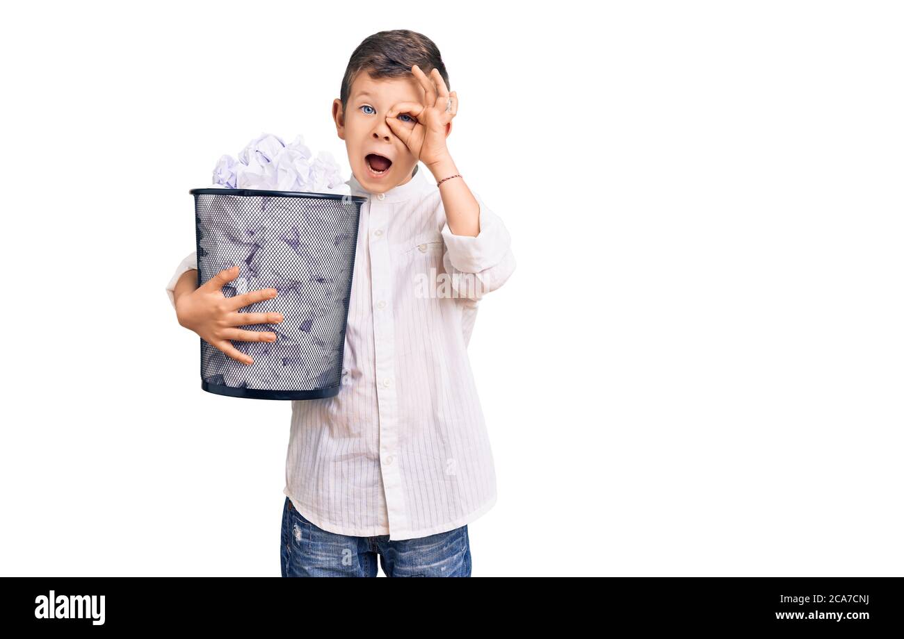 Cute blond kid holding paper bin full of crumpled papers smiling happy ...