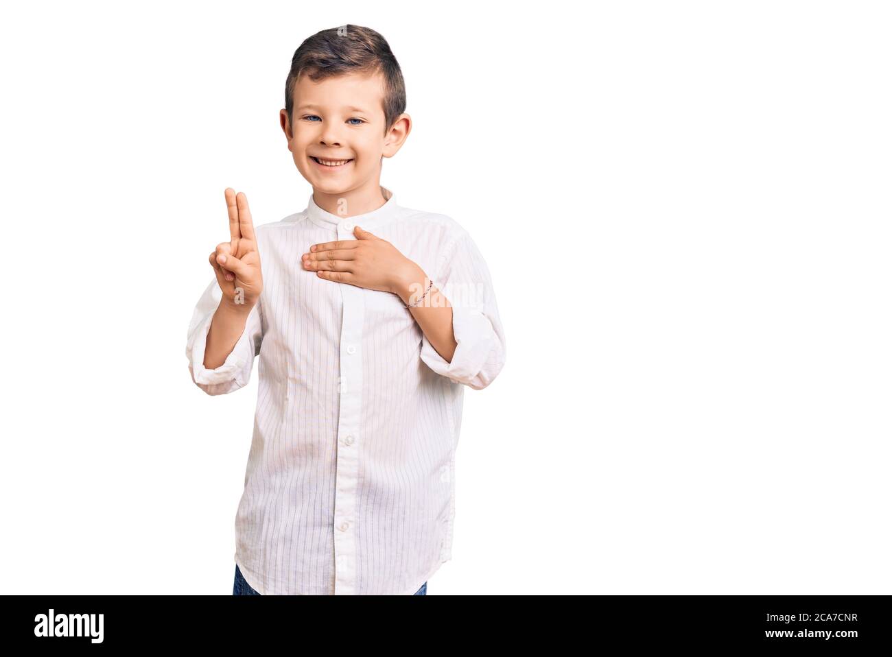 Cute blond kid wearing elegant shirt smiling swearing with hand on ...