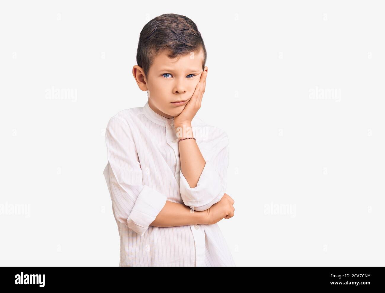Cute blond kid wearing elegant shirt thinking looking tired and bored ...