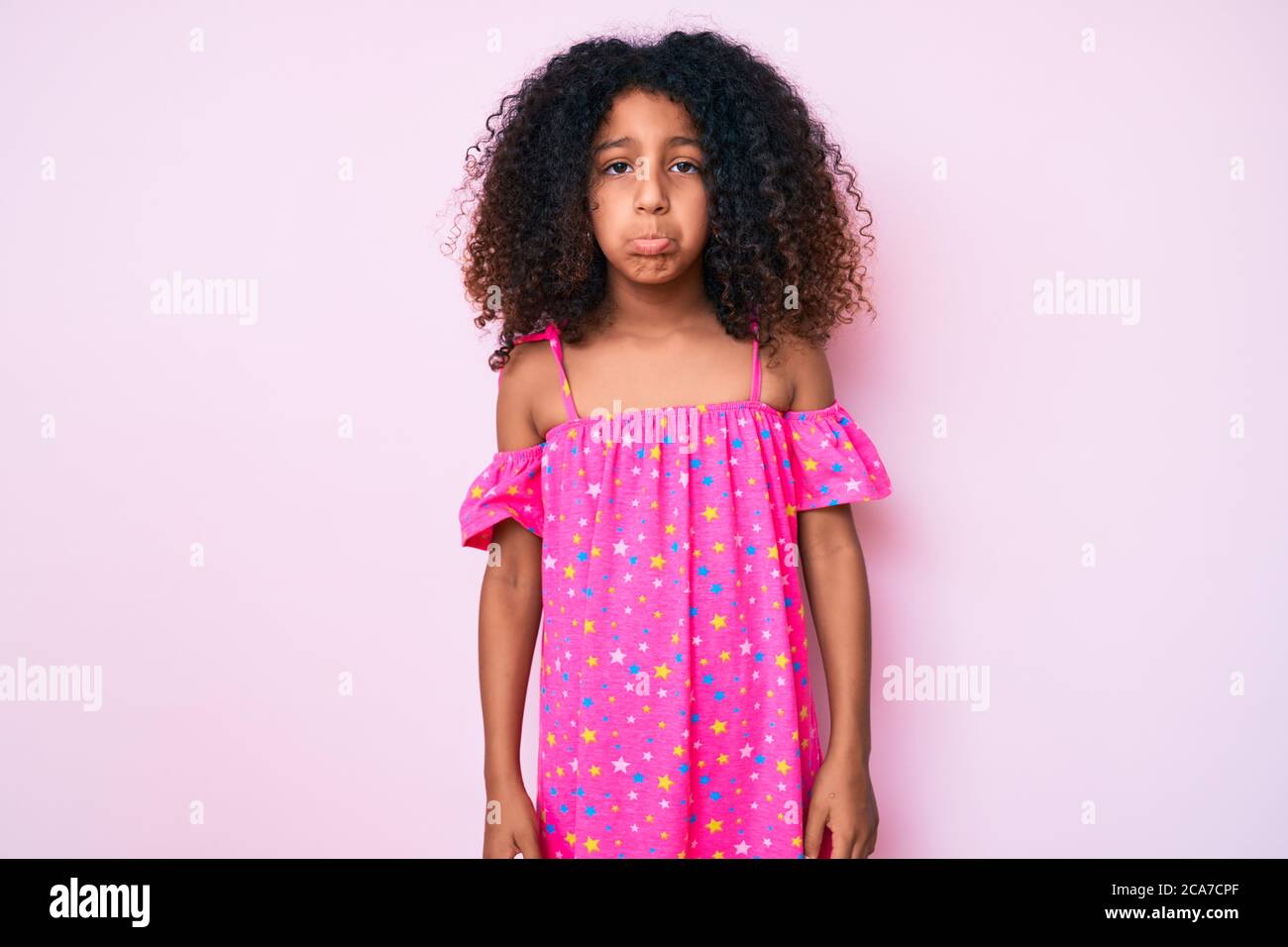 African american child with curly hair wearing casual dress depressed ...