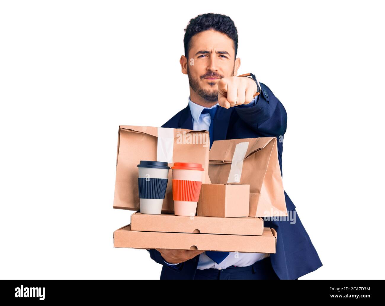 Young hispanic man wearing suit holding takeaway coffee and food ...