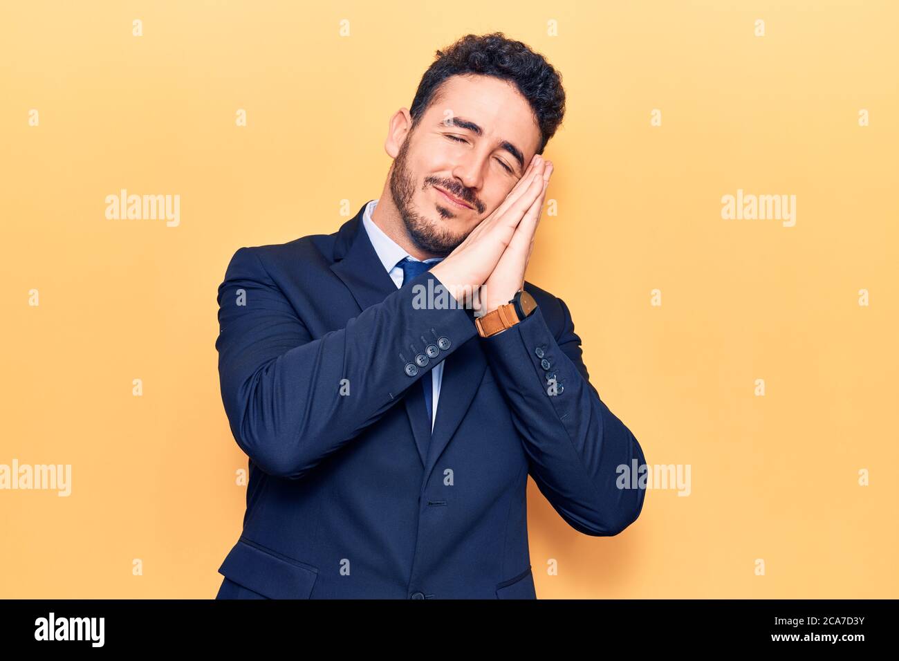 Young hispanic man wearing suit sleeping tired dreaming and posing with ...