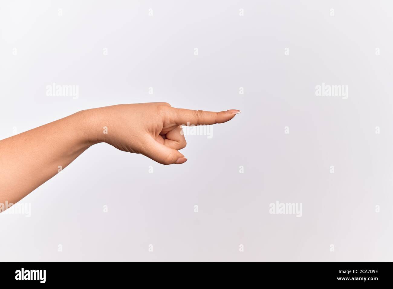 Hand of caucasian young woman pointing with index finger to the side, suggesting and selecting a ...