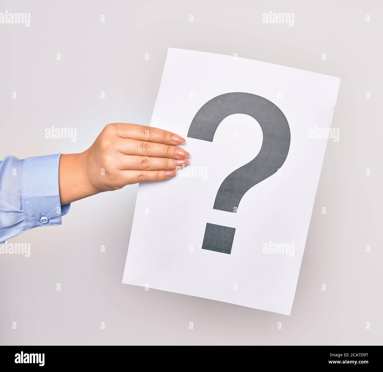 Hand of caucasian young woman holding paper with question mark symbol ...