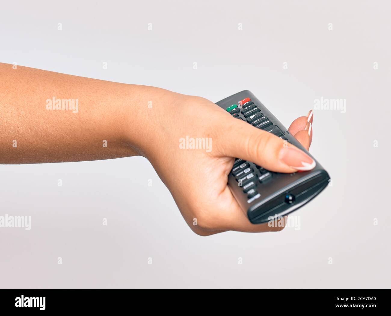 Hand of caucasian young woman changing television channel holding tv ...