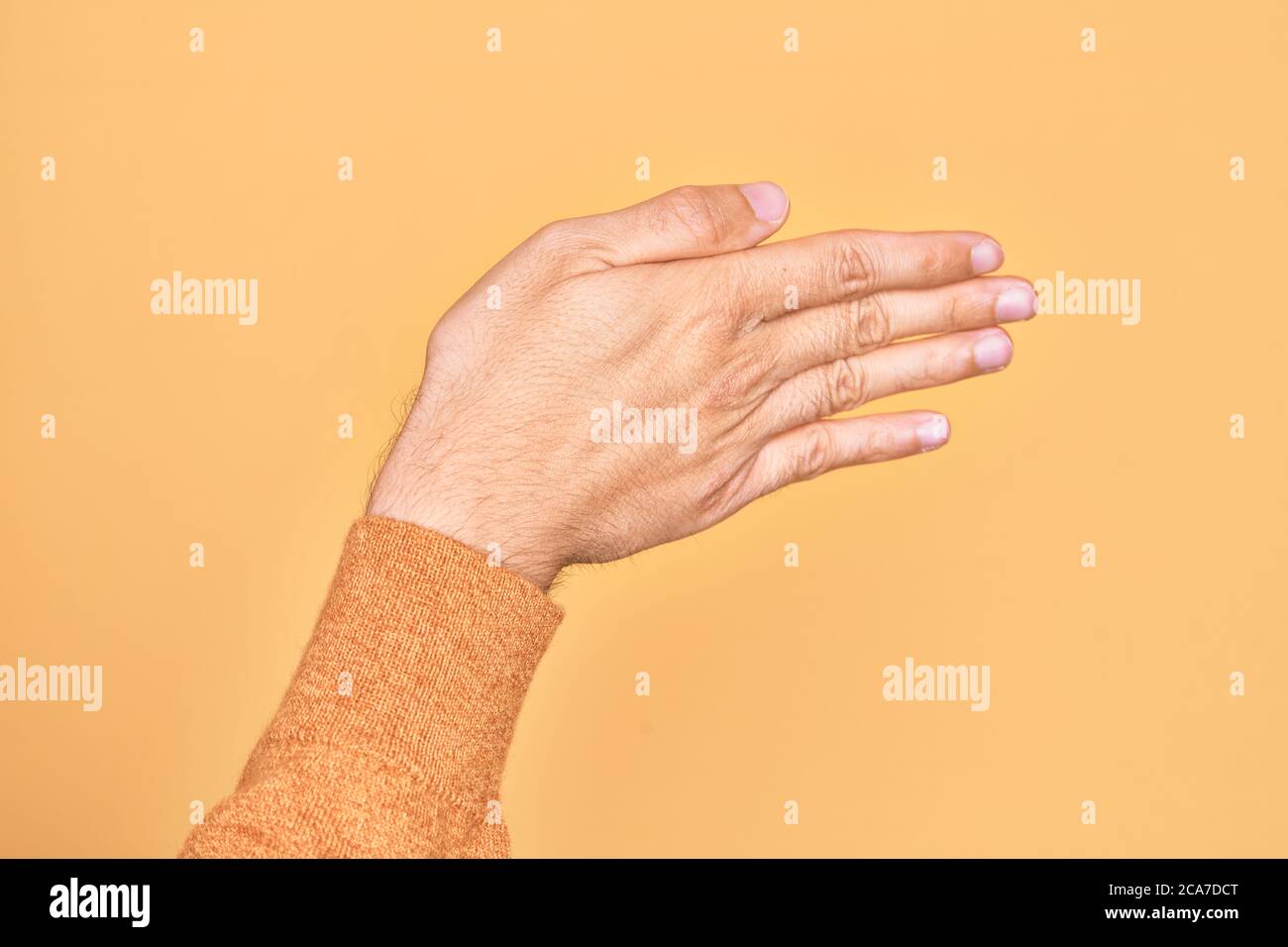 Hand of caucasian young man showing fingers over isolated yellow ...