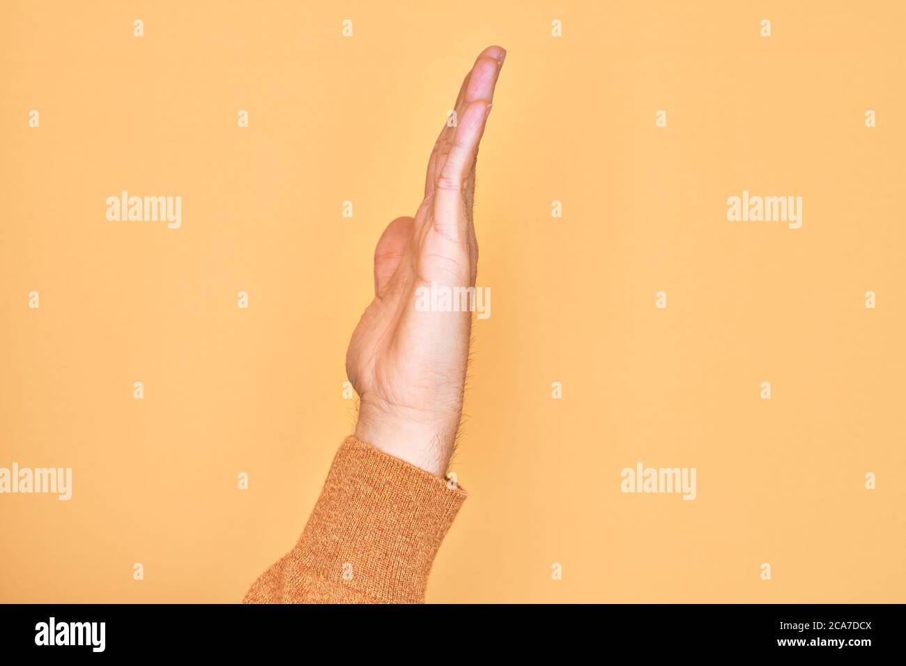 Hand of caucasian young man showing fingers over isolated yellow ...