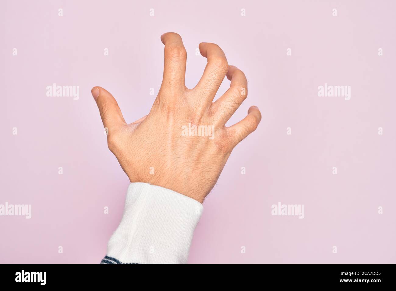 Hand of caucasian young man showing fingers over isolated pink ...