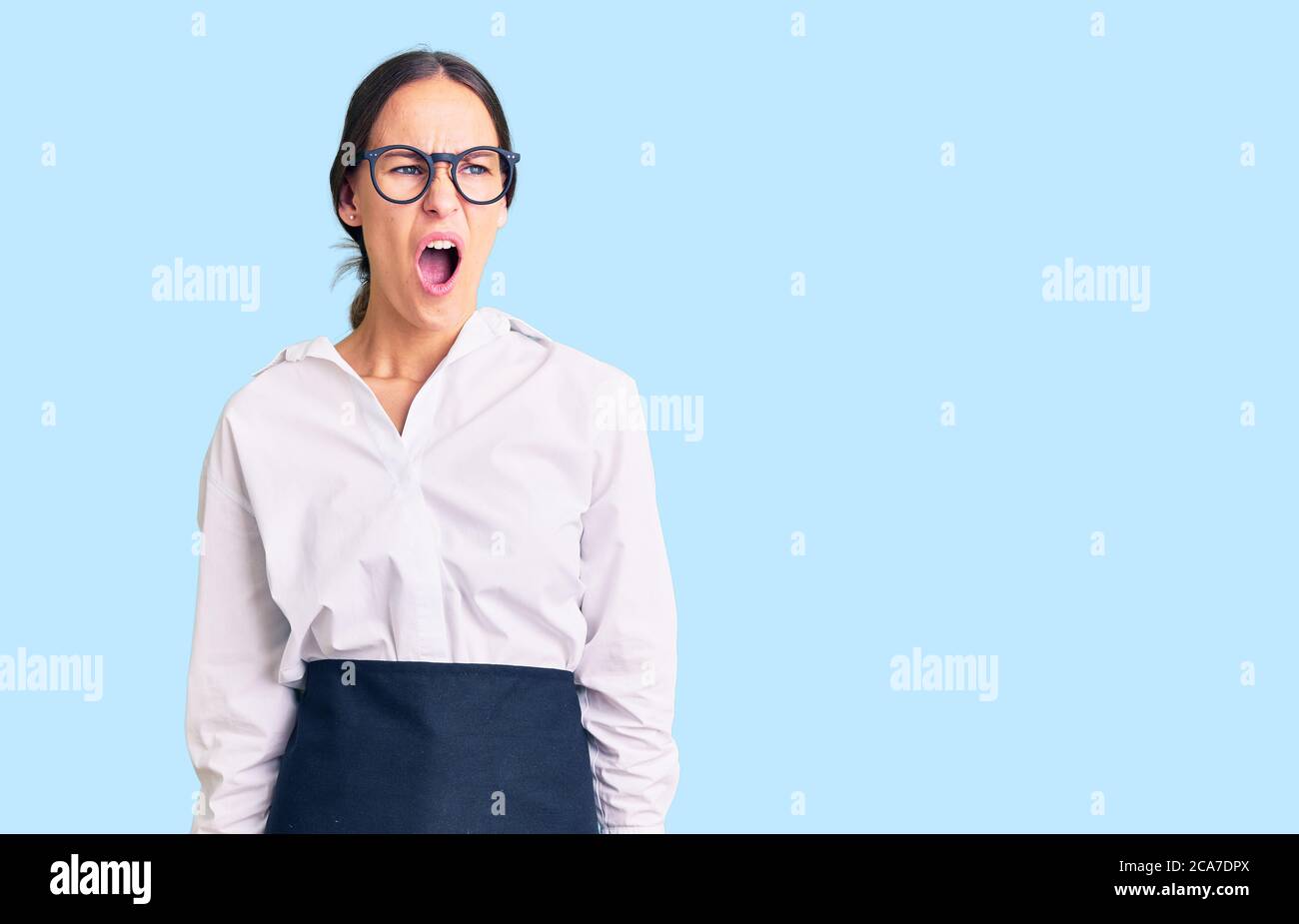 Beautiful brunette young woman wearing professional waitress apron ...