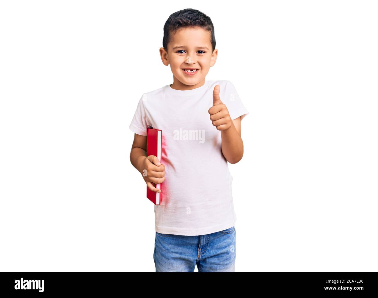 Little cute boy kid reading a book smiling happy and positive, thumb up ...