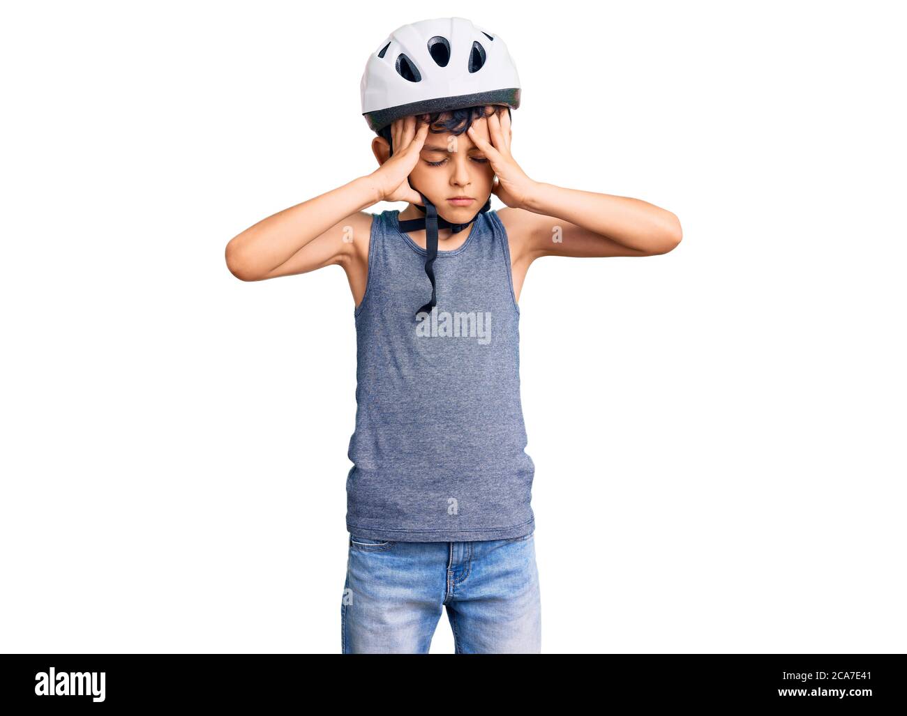 Little cute boy kid wearing bike helmet suffering from headache ...