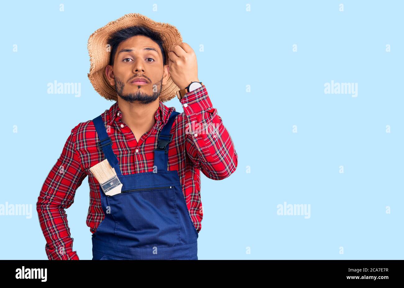 Handsome latin american young man weaing handyman uniform doing italian ...