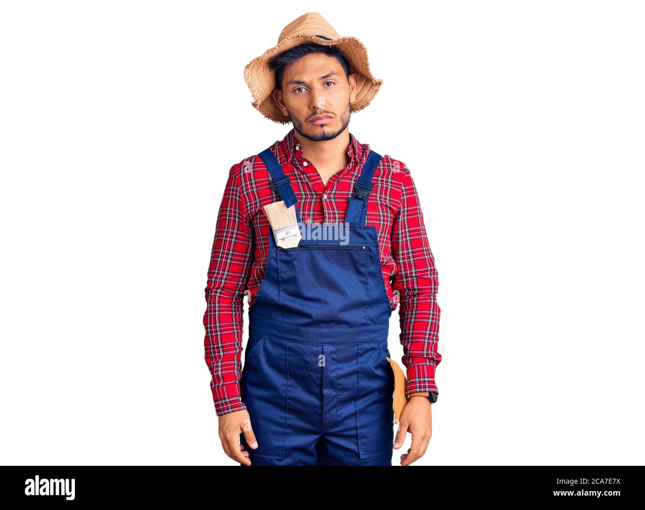 Handsome latin american young man weaing handyman uniform depressed and ...
